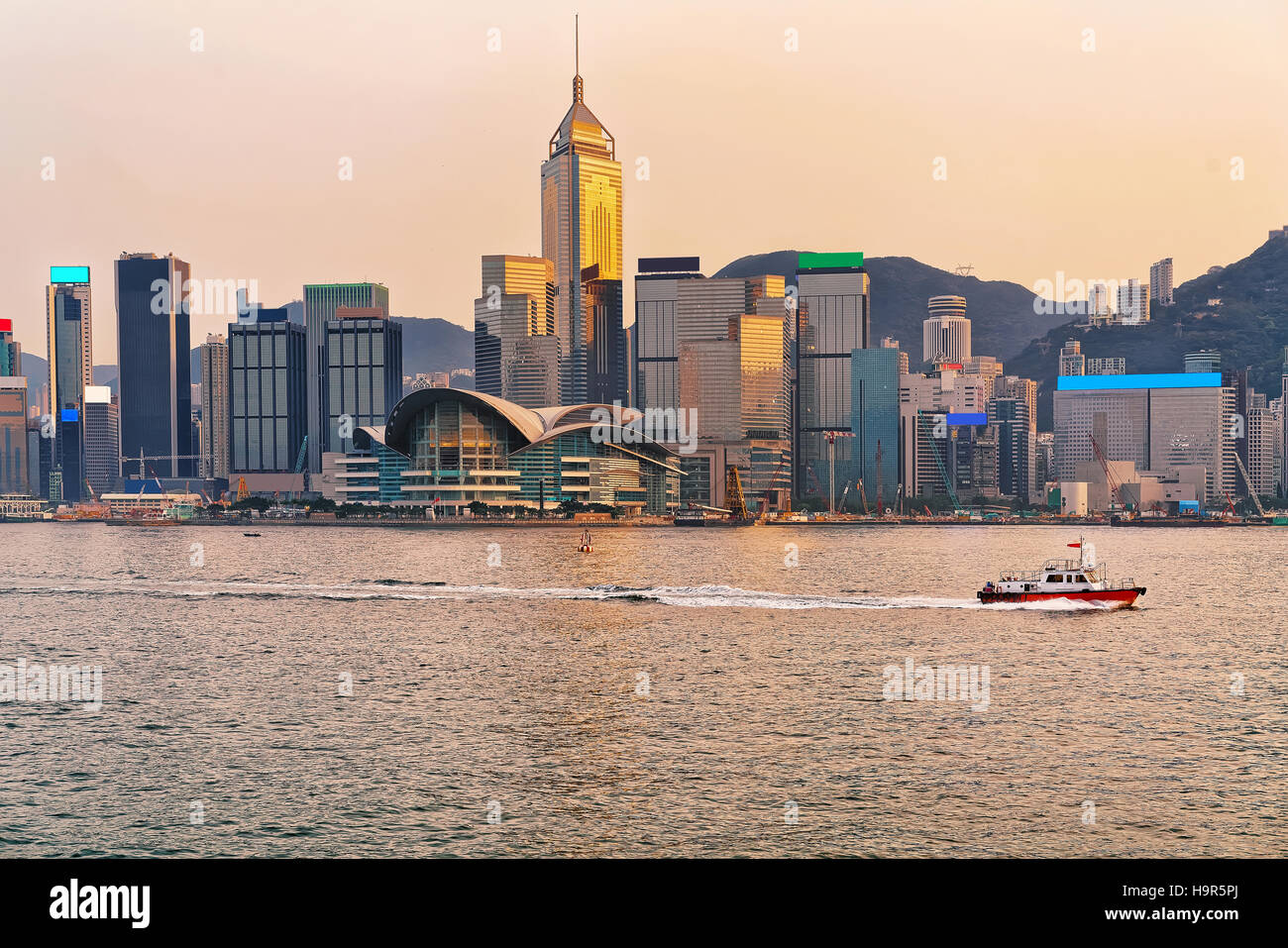 Water boat at Victoria Harbor in Hong Kong at sunset. View from Kowloon ...