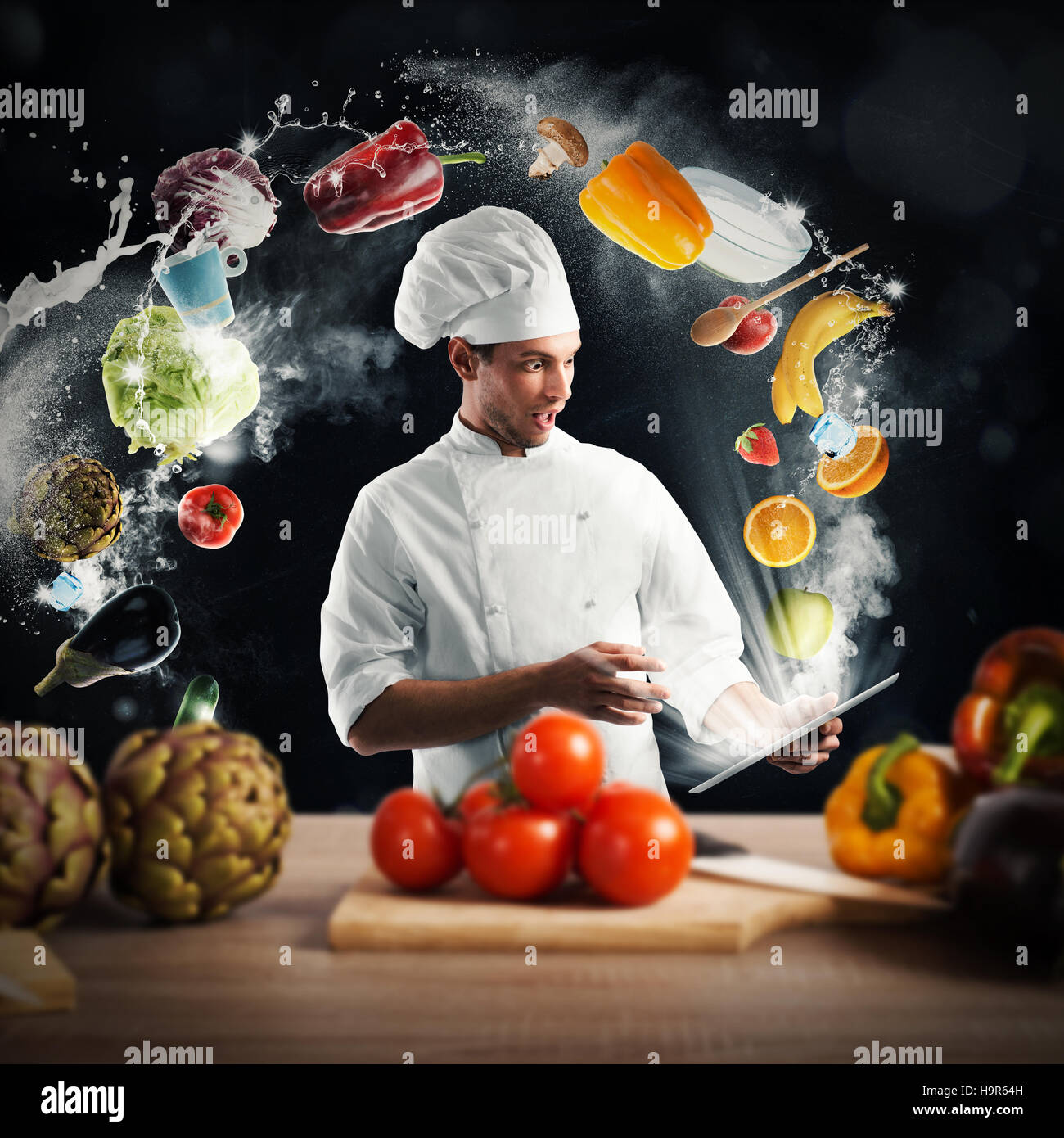 Cooking recipe from tablet Stock Photo - Alamy