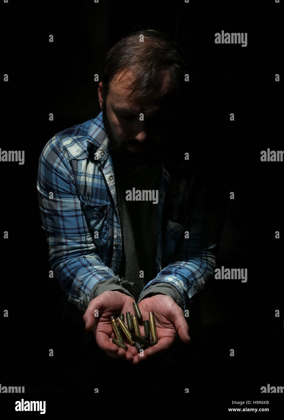 bullet in hands man Stock Photo - Alamy