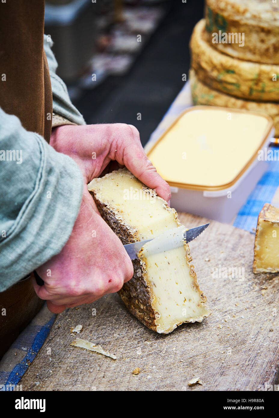 Cheese being cut into pieces Stock Photo - Alamy