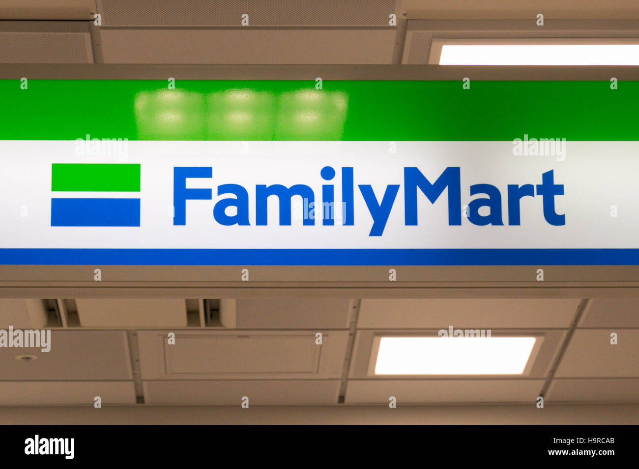 A FamilyMart signboard on display at its convenience store in Shinjuku ...