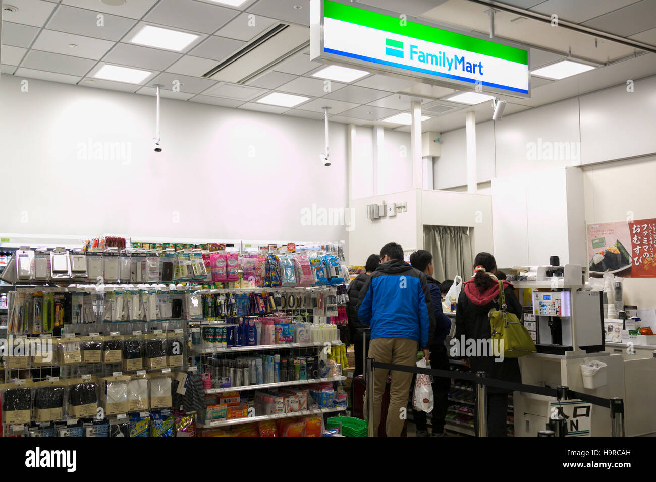 Travelers buy products at a new FamilyMart convenience store in ...