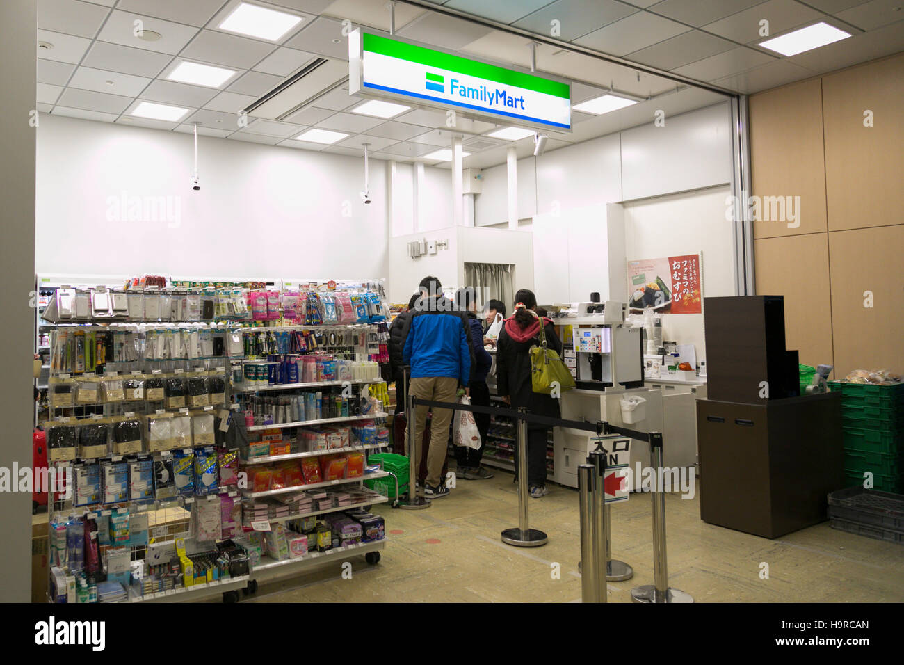 Travelers buy products at a new FamilyMart convenience store in ...