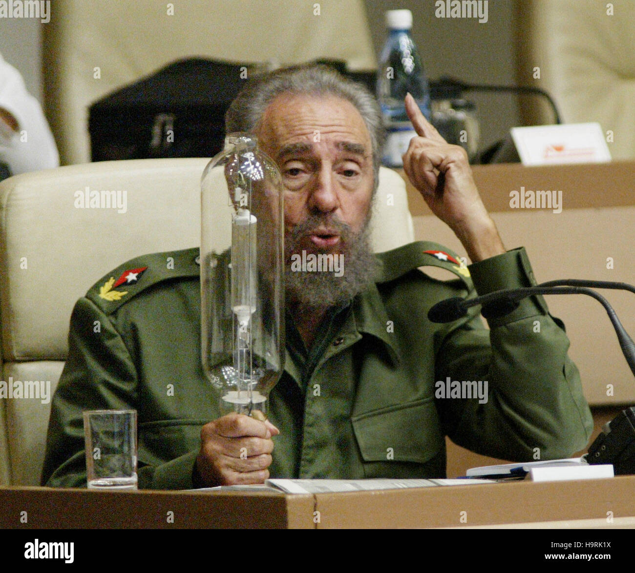 Cuban President Fidel Castro holds a ligth bulb while talking during a ...