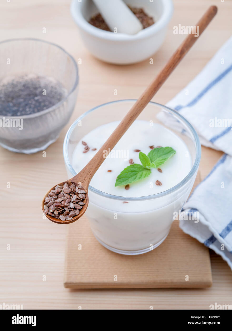 Nutritious flax seeds with glass of greek yogurt and wooden spoo Stock ...