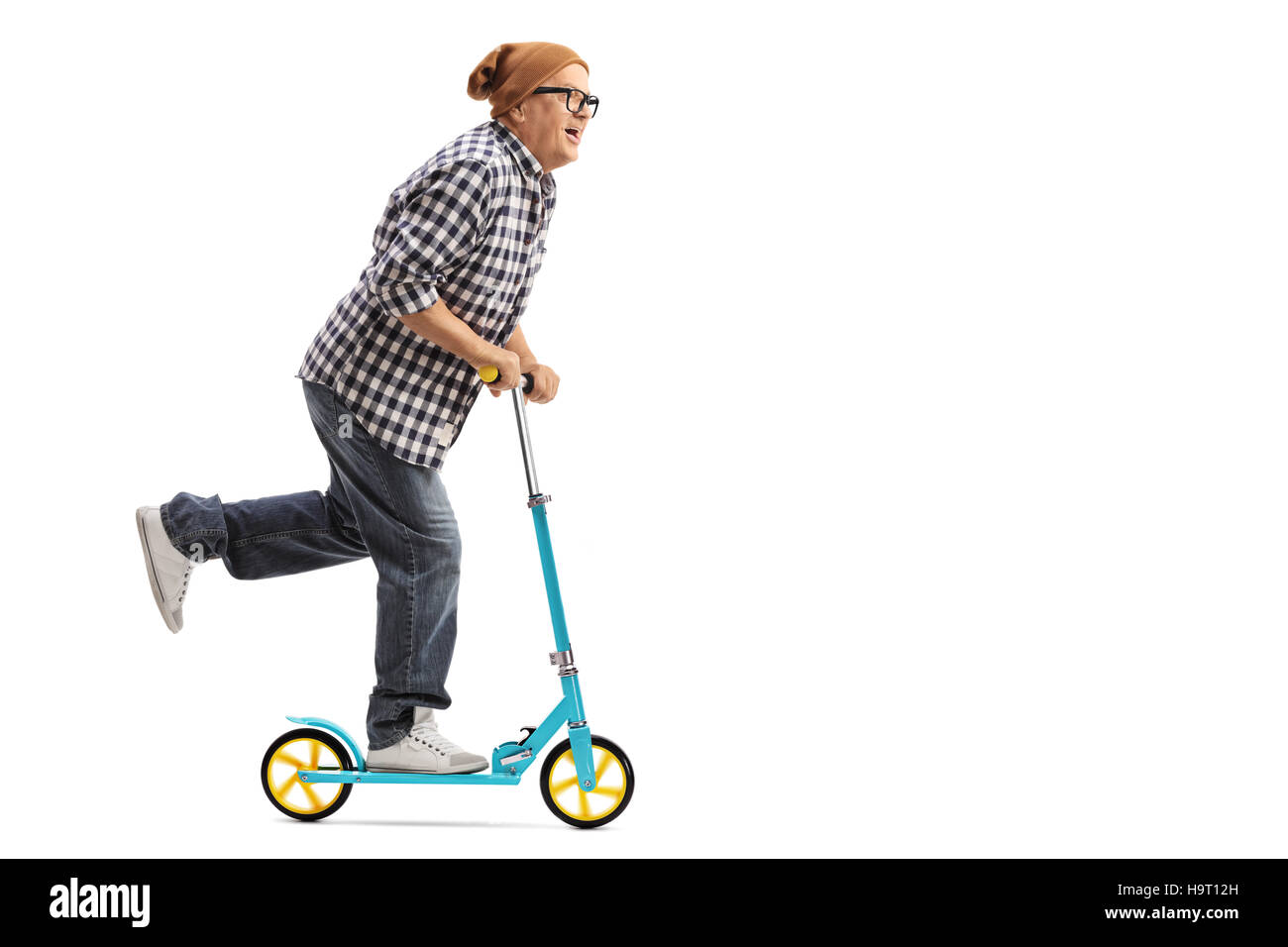 Full length profile shot of a cool mature man riding a scooter isolated ...