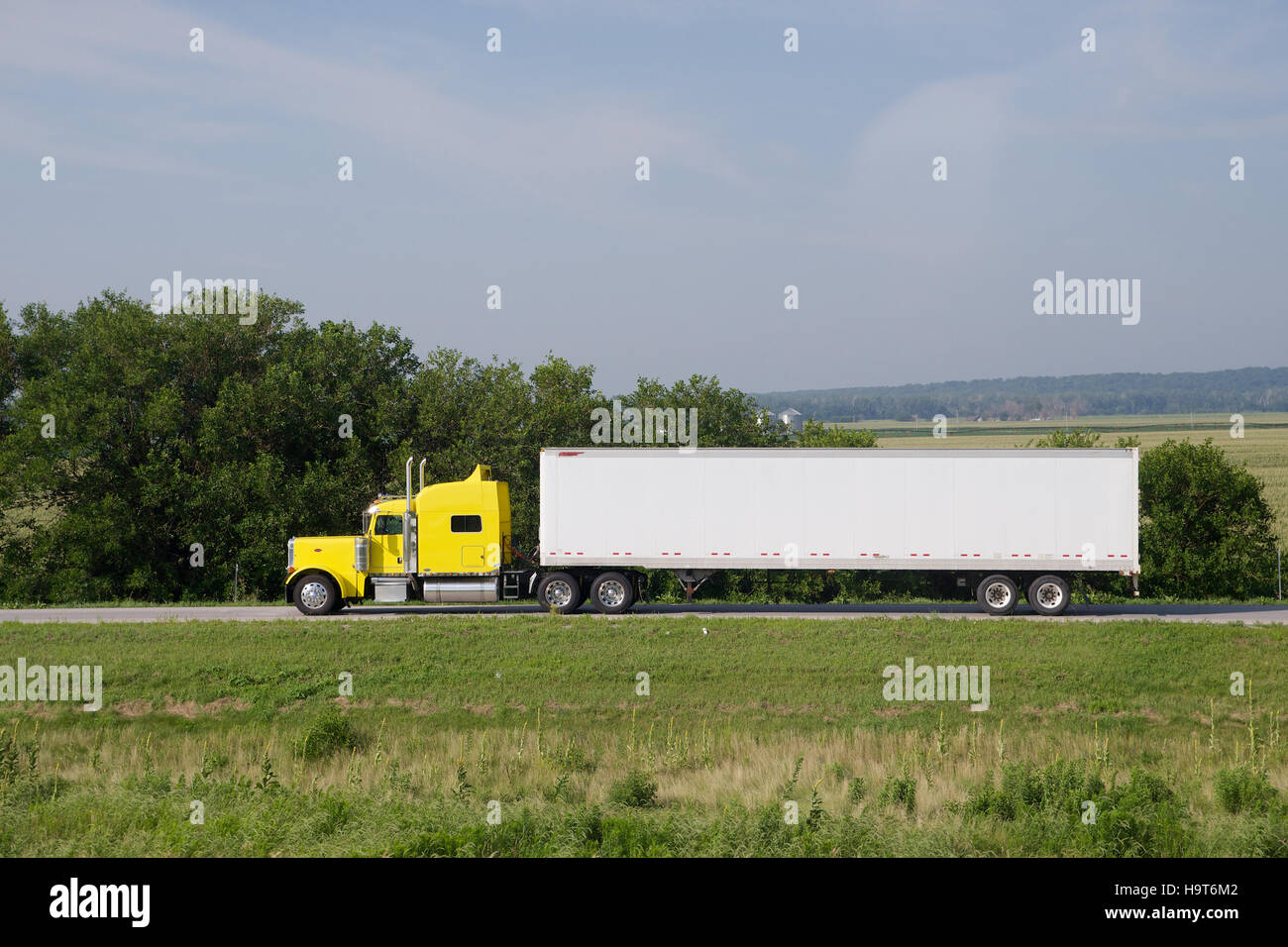 Yellow Peterbilt truck and trailer on Highway in the state of Iowa, USA ...