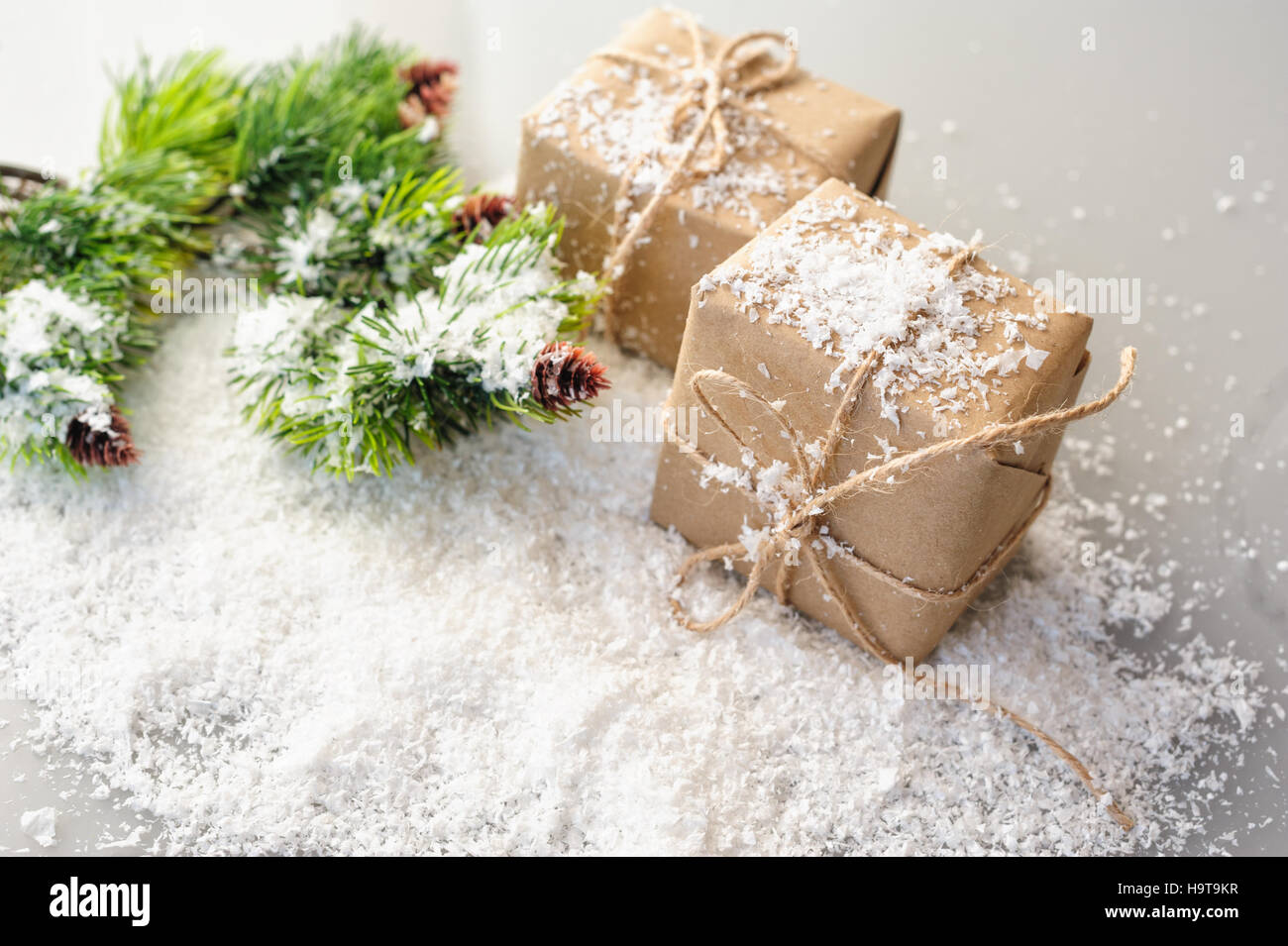 gift boxes of kraft paper with spruce branches on white background ...