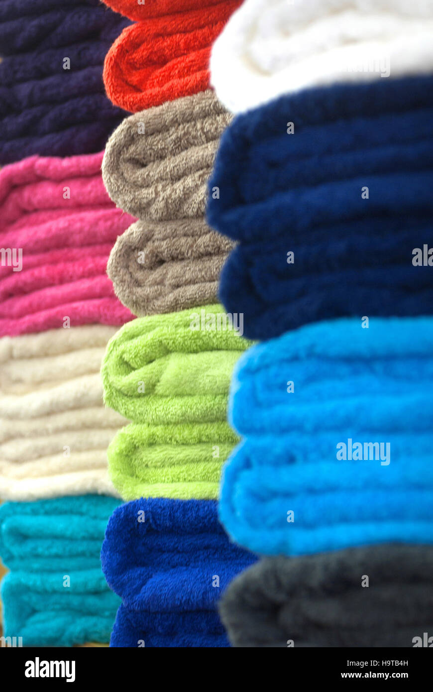 Stack of coloured towels / Toweling Stock Photo - Alamy