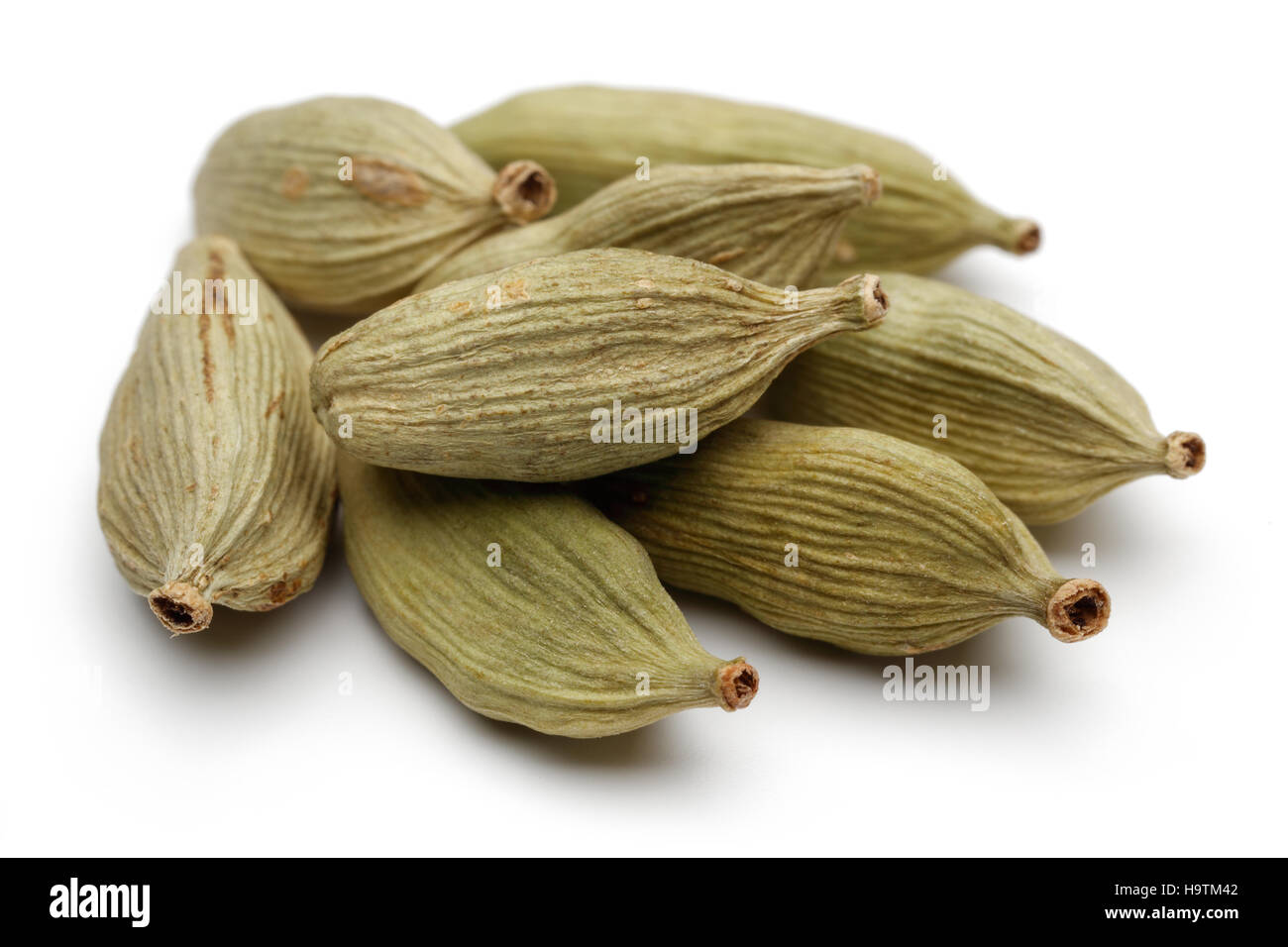 Cardamom seeds on a white background Stock Photo - Alamy