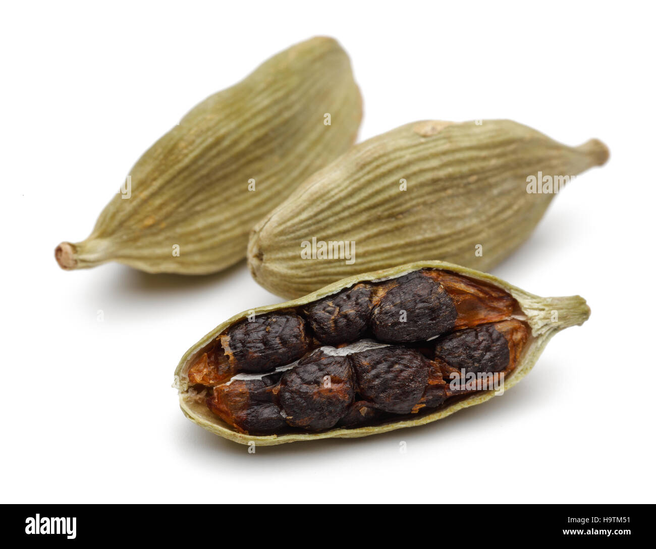 Green cardamom pods and seeds close up on white background Stock Photo ...