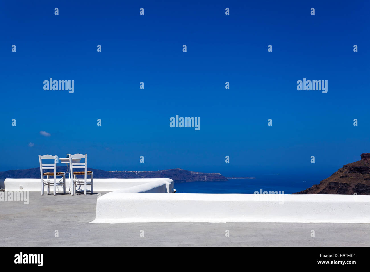 Two chairs with table on a terrace, Thira, Fira, Santorini, Cyclades ...