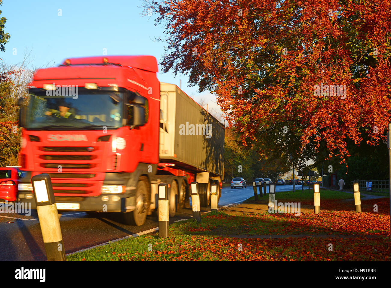 lorry travelling on country by autumn coloured trees near york ...