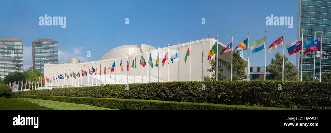 UN United Nations general assembly building with world flags flying in ...