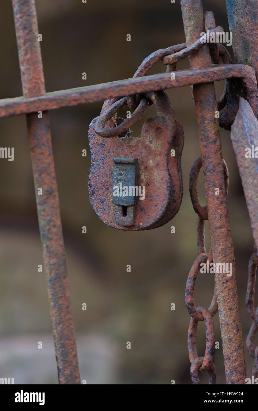 Rusty Lock forming part of an iron fence Stock Photo - Alamy