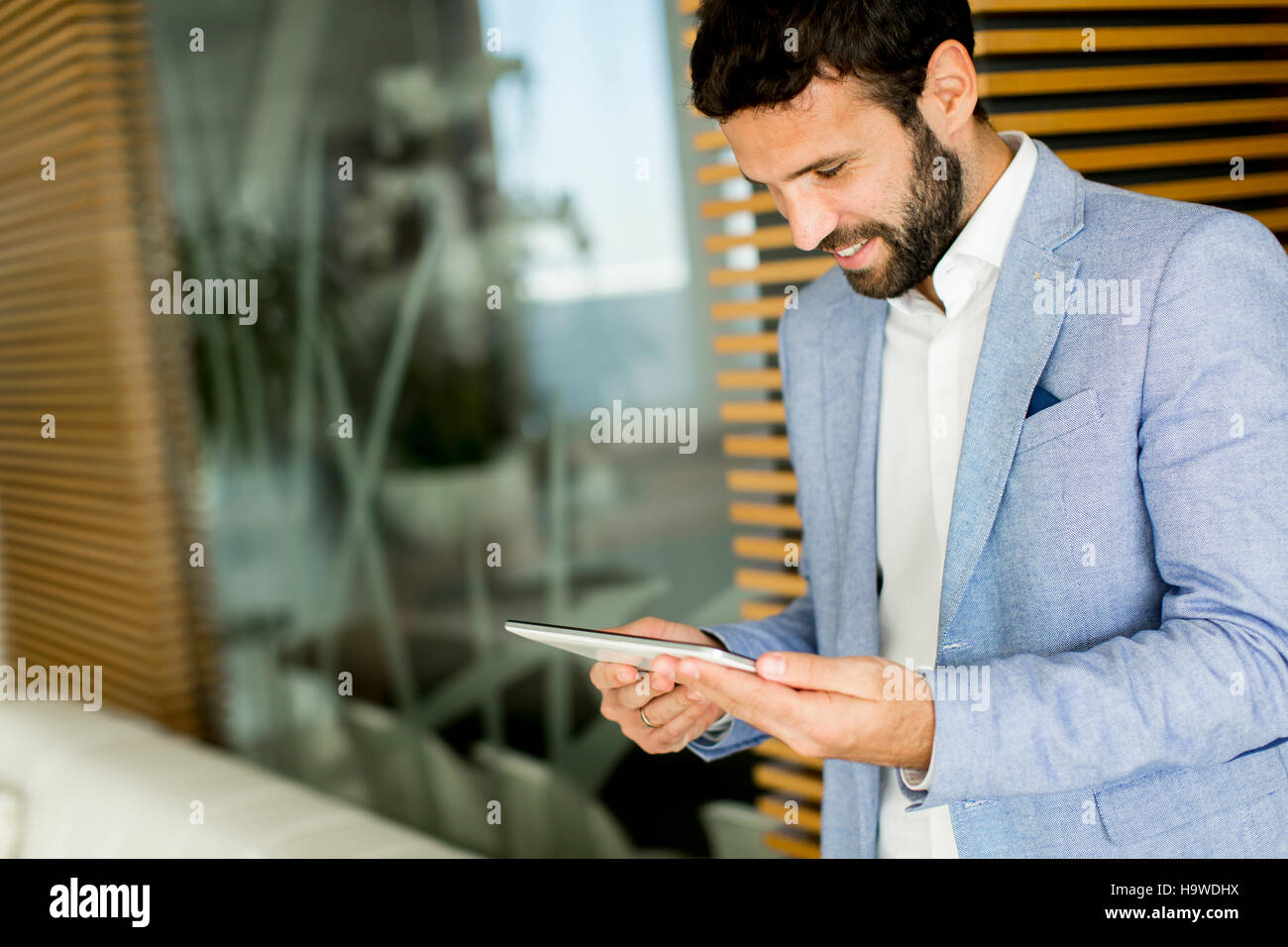 Young business man standing and holding tablets in the hands Stock ...