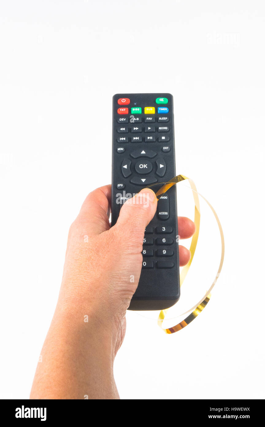 hand holding a remote control in a festive gold ribbon on white ...
