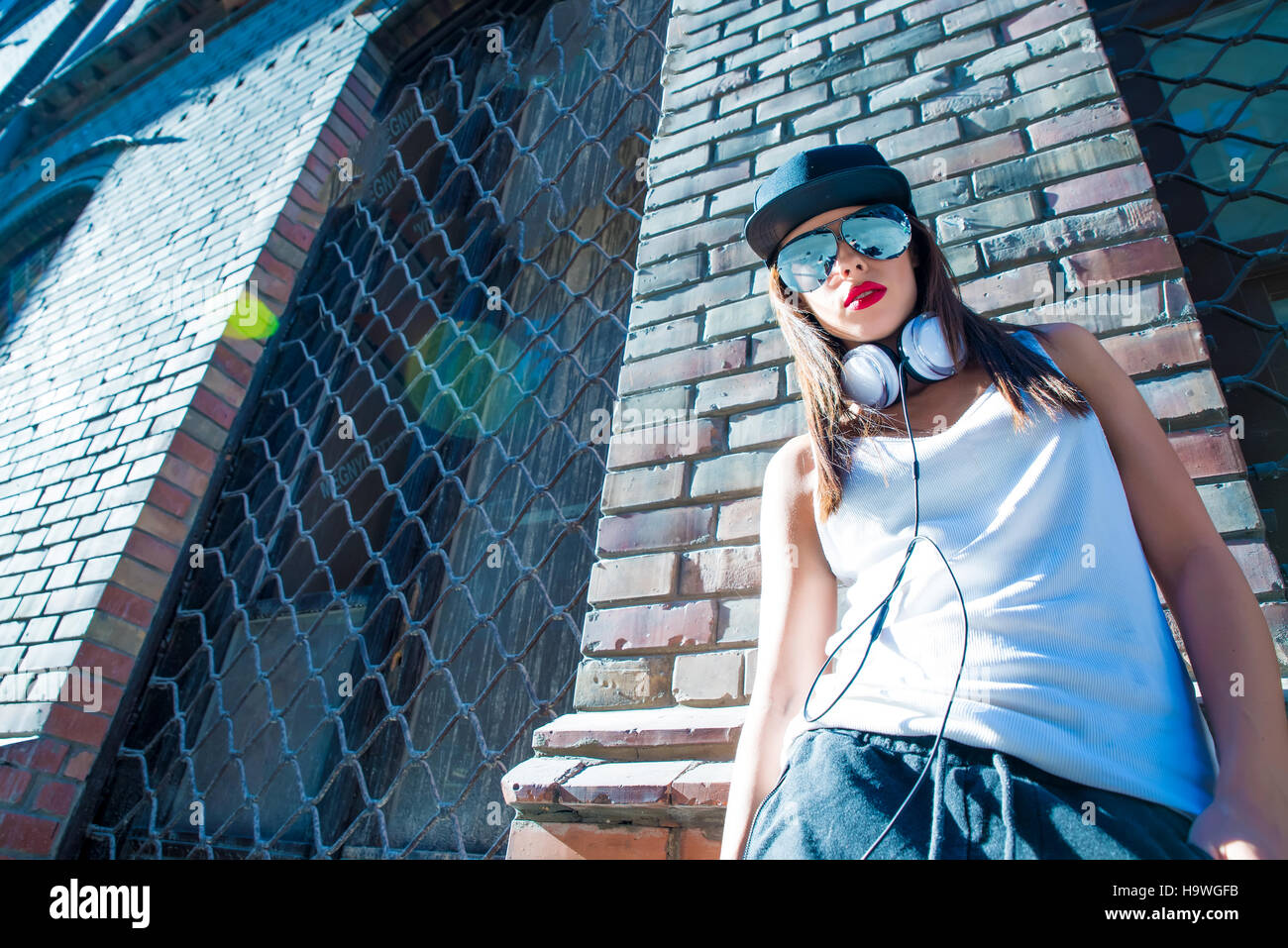 A beautiful young Hip Hop Rapper girl with Headphones in a urban ...