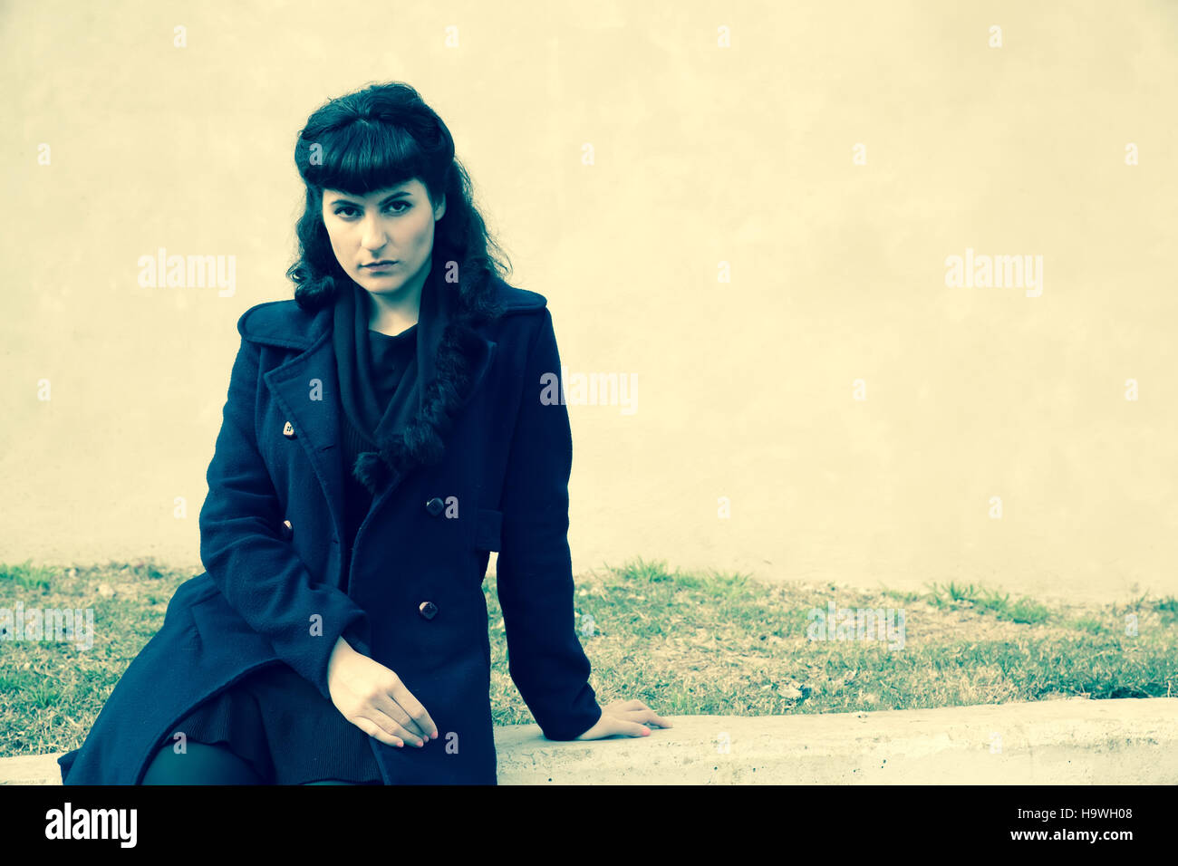 A retro styled girl being bored in a urban environment Stock Photo - Alamy