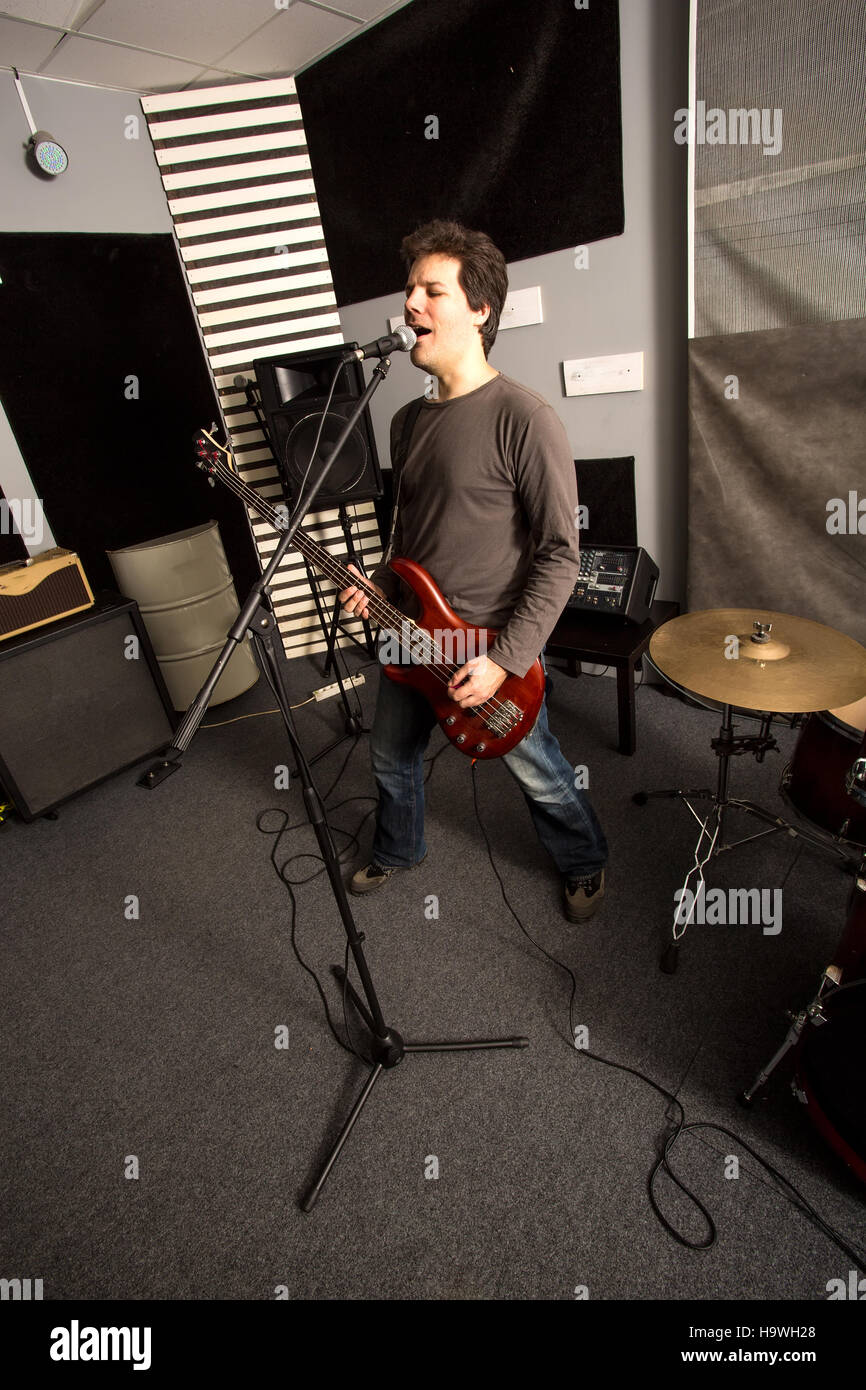 A Rock singer playing bass in the rehearsal Studio Stock Photo - Alamy