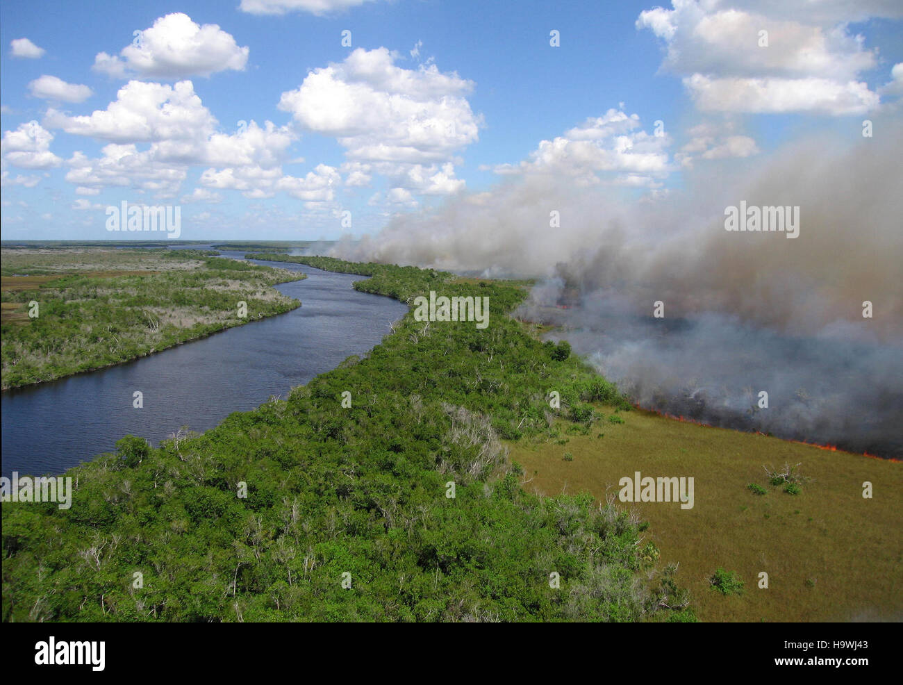This image captures a controlled burn in the Everglades National Park ...