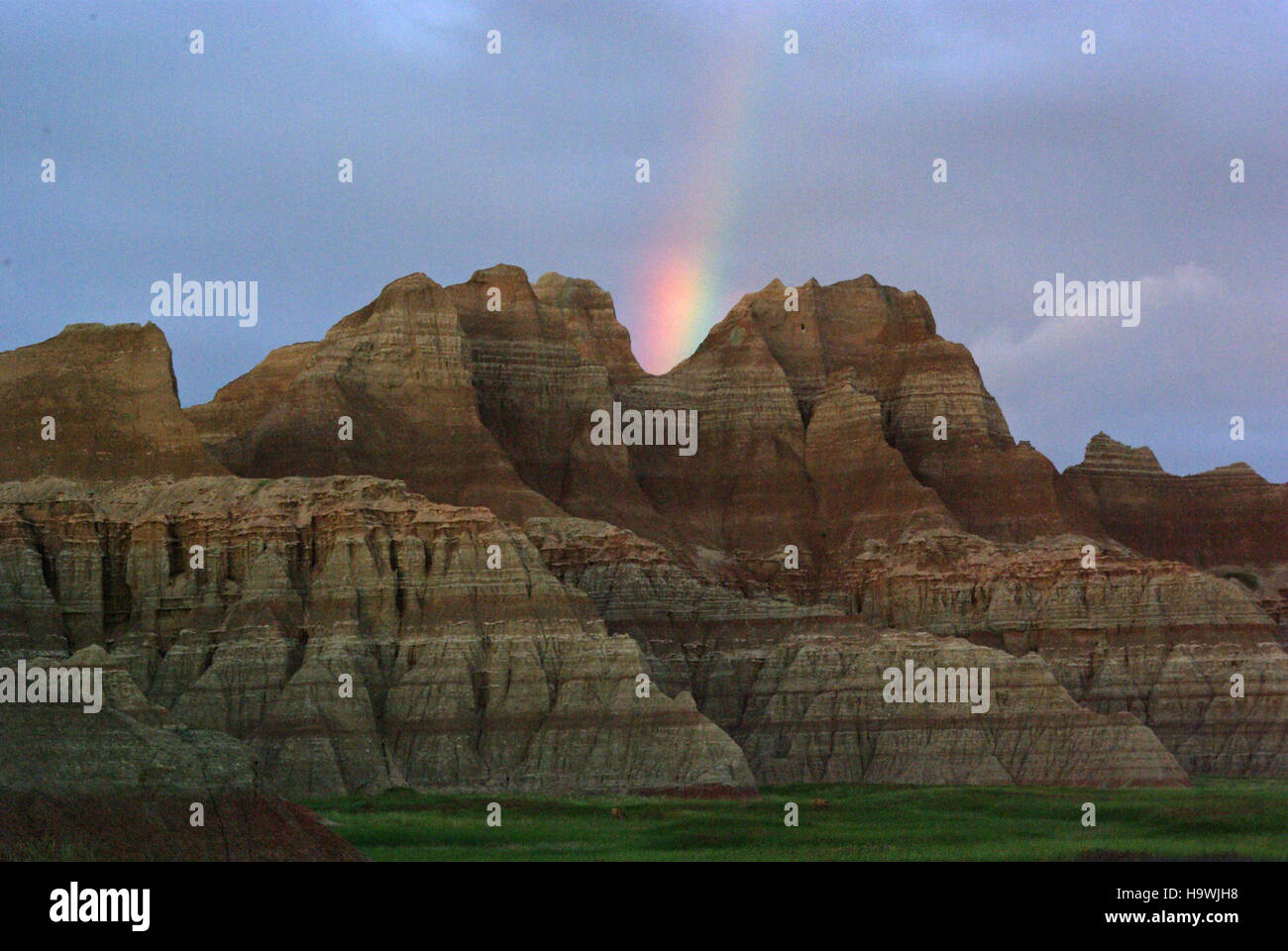 The vibrant rainbow over the unique rock formations of Badlands ...