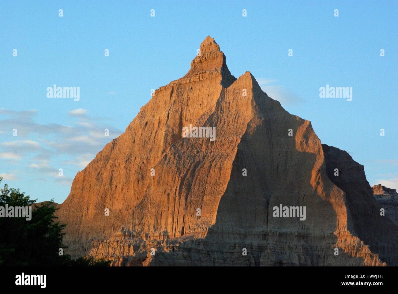 A stunning sunset casts vibrant colors over Angel Butte in Badlands ...