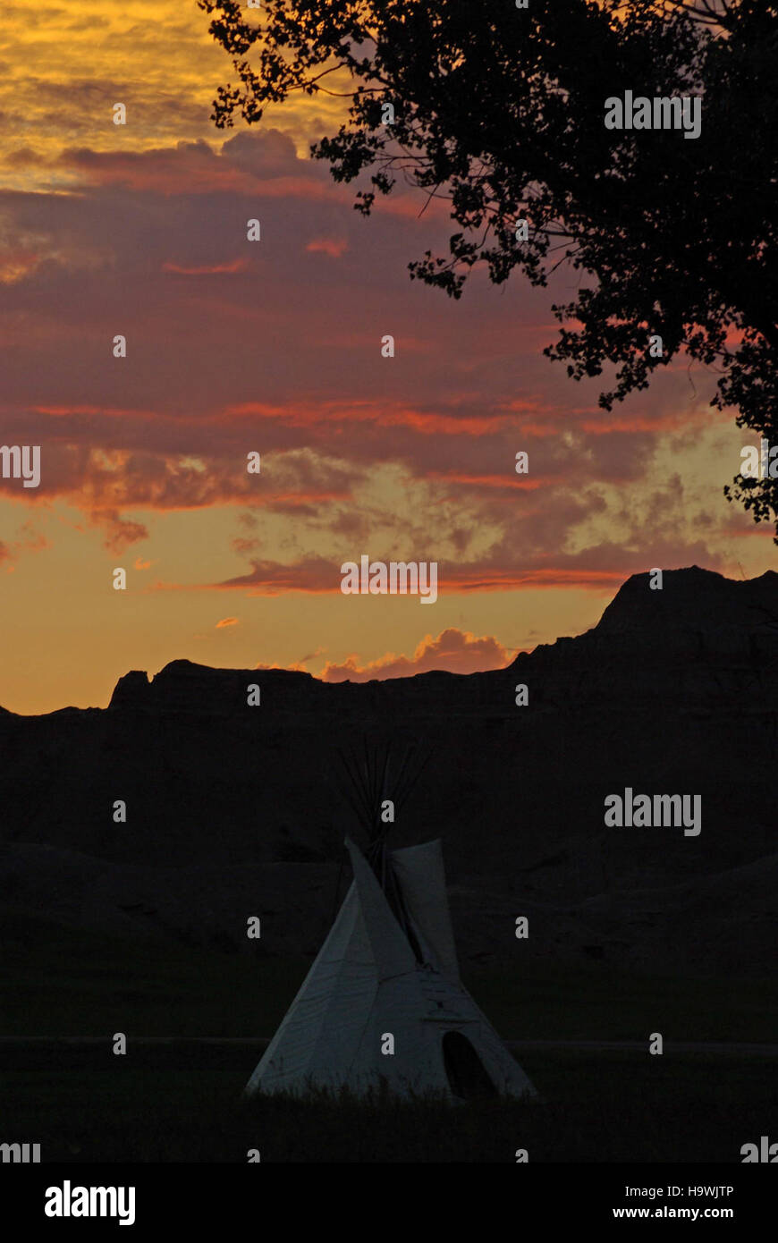 A scenic view of sunset and tipis in Badlands National Park highlights ...