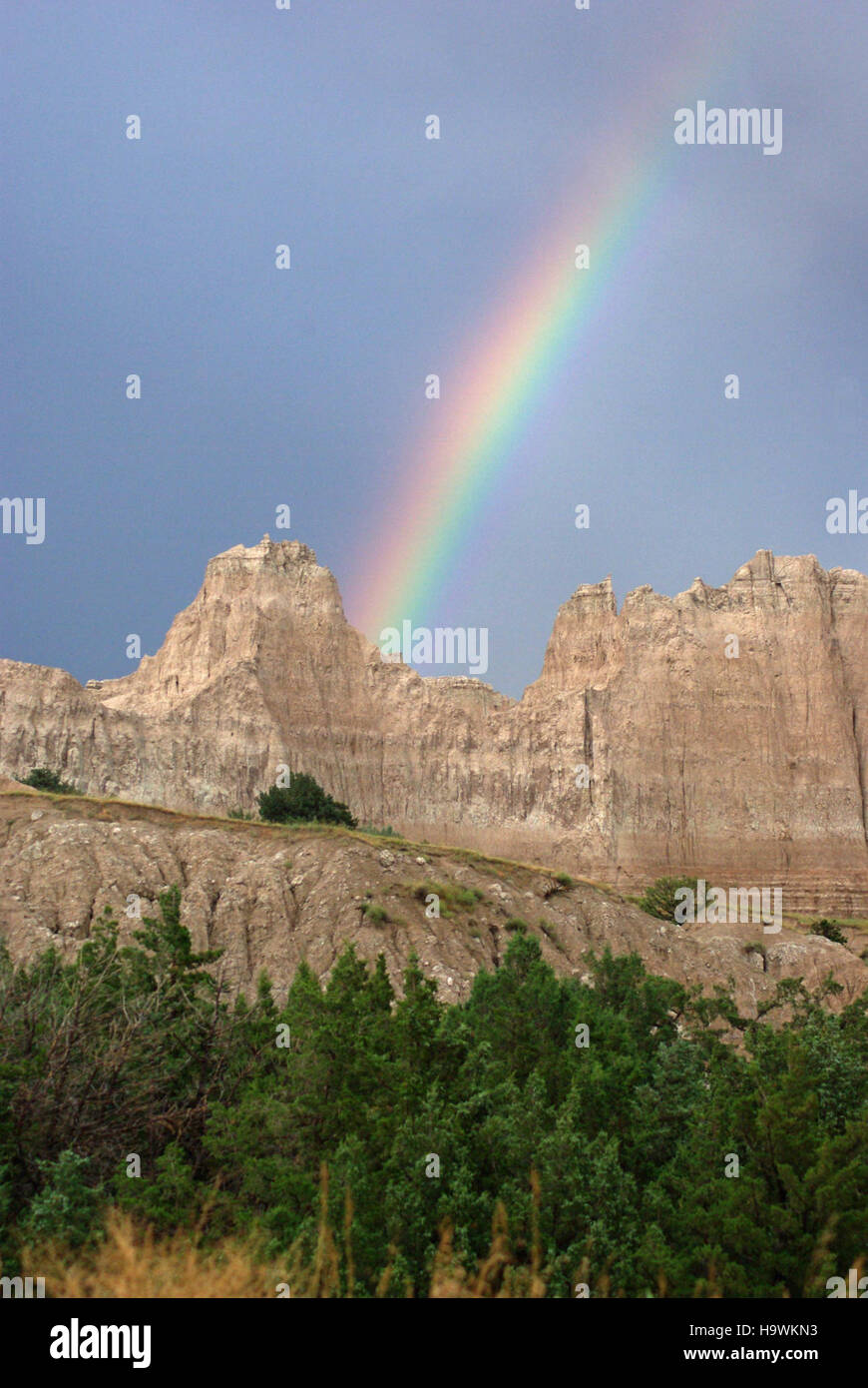 This image captures a rainbow over Cedar Pass in Badlands National Park ...