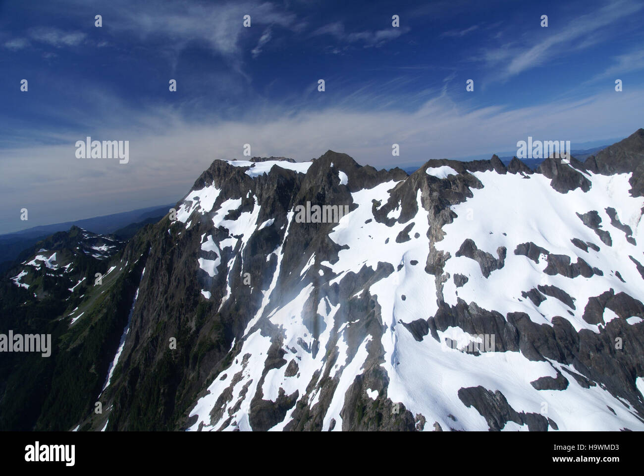 An aerial view of glaciers and mountain peaks in Olympic National Park ...