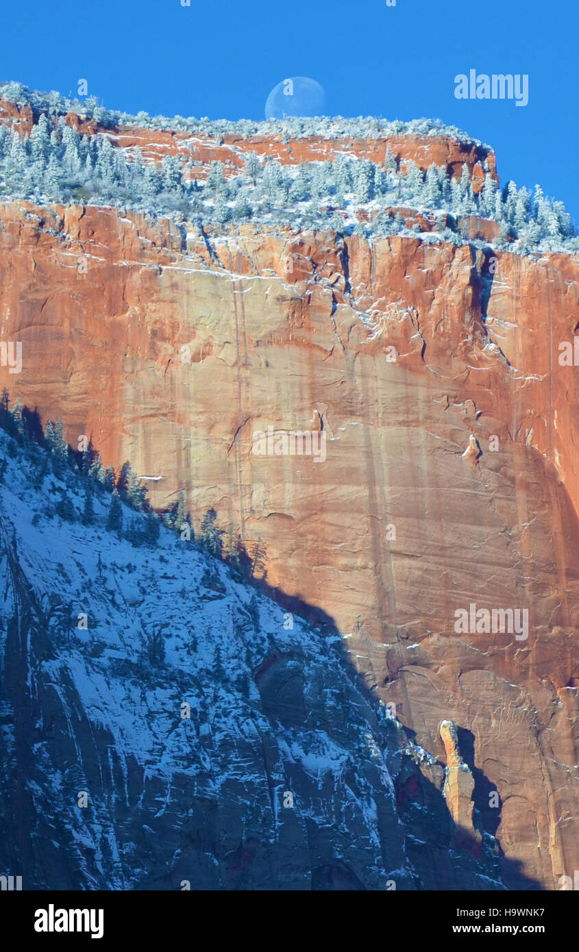 A moonset occurring behind The West Temple, a prominent rock formation ...