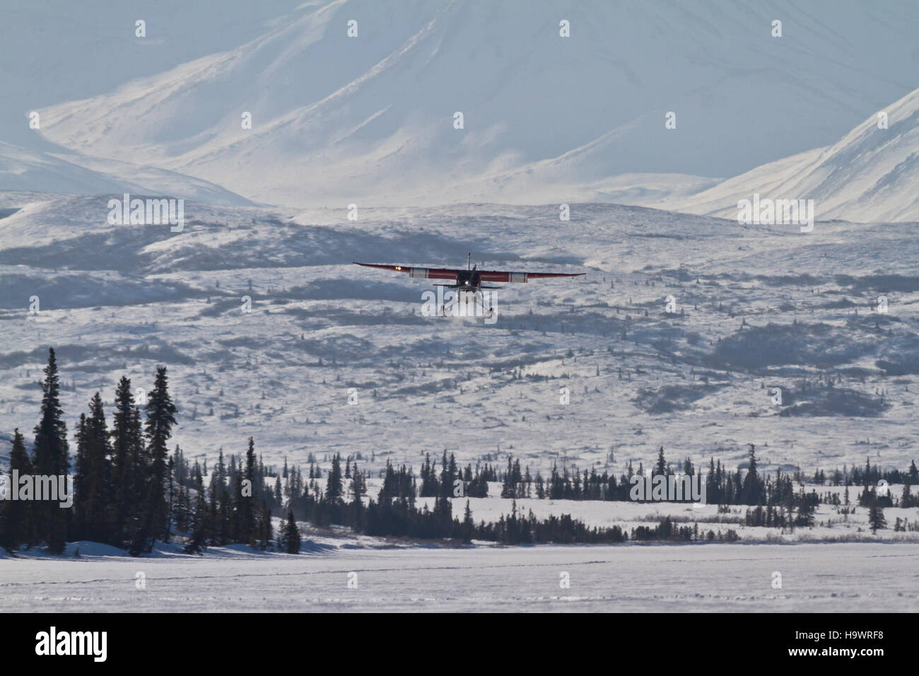 A plane approaches Wonder Lake in Denali National Park, offering a ...