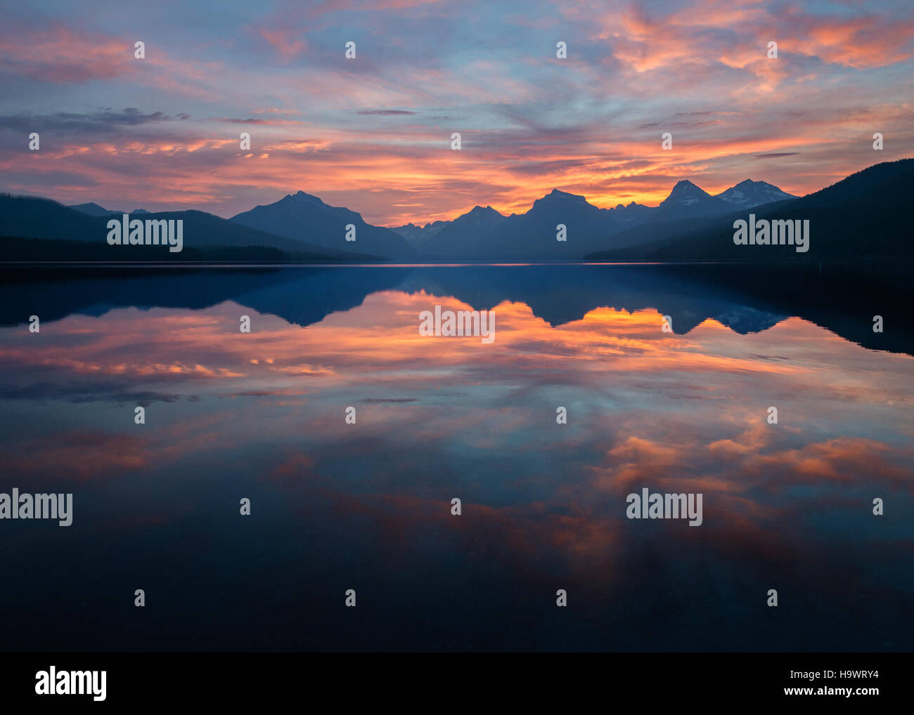 A breathtaking sunrise over the mountains at Glacier National Park ...