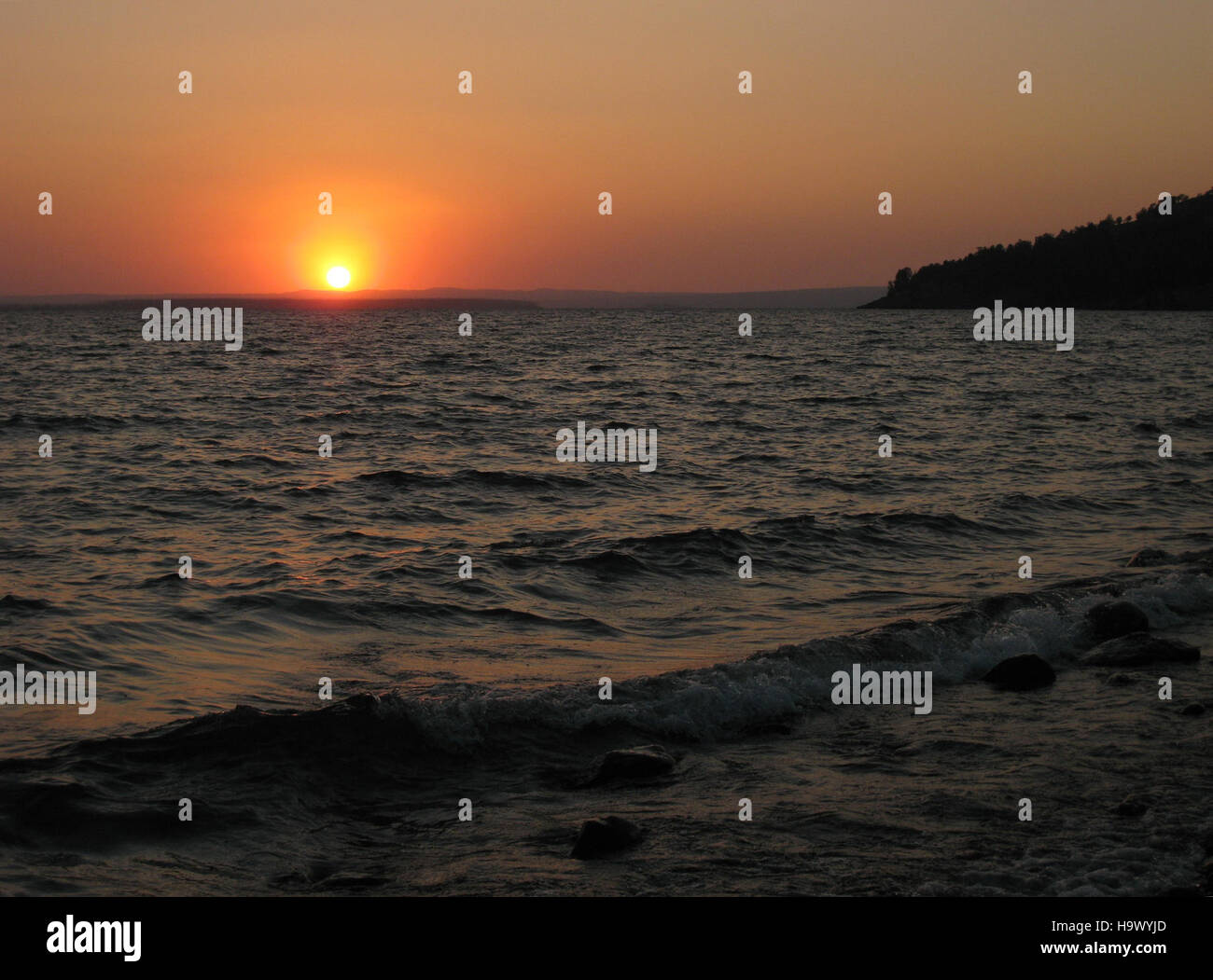 A stunning sunset over Yellowstone Lake, captured in this photograph ...
