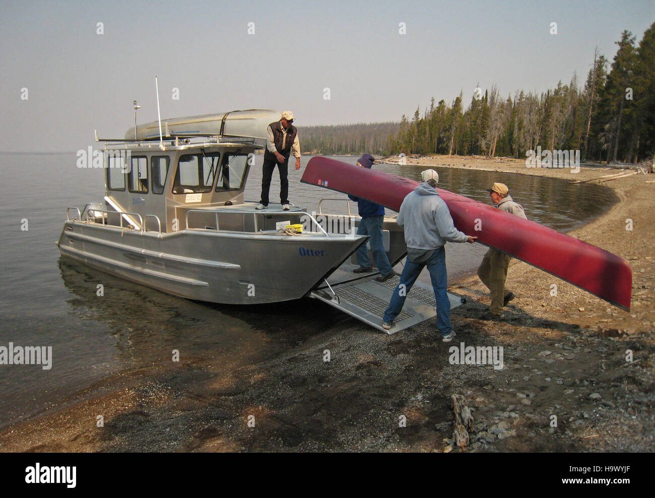 This image from Yellowstone National Park shows a canoe being picked up ...
