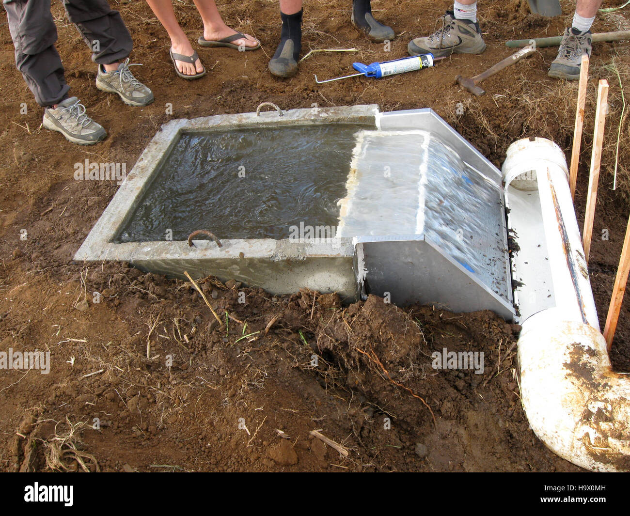 This photo shows water cascading over a newly installed fish screen ...
