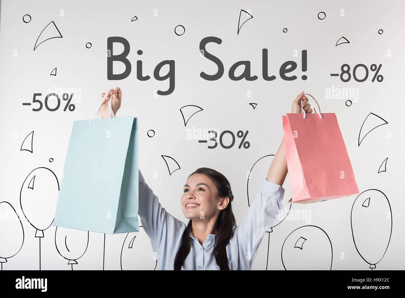 Cheerful woman feeling happy with big sales in mall Stock Photo - Alamy