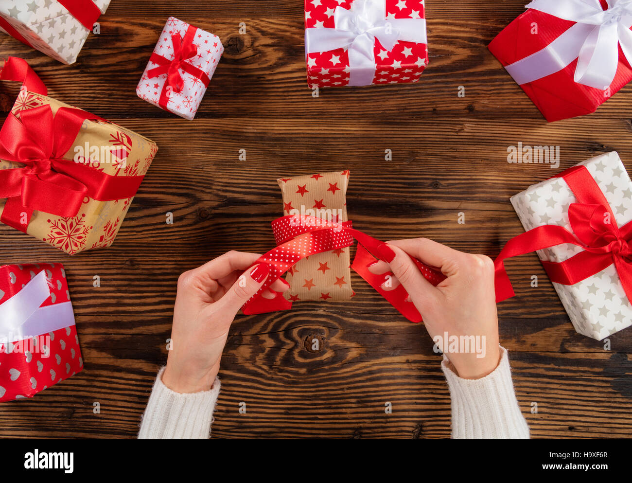 Woman hand packing gifts Stock Photo - Alamy