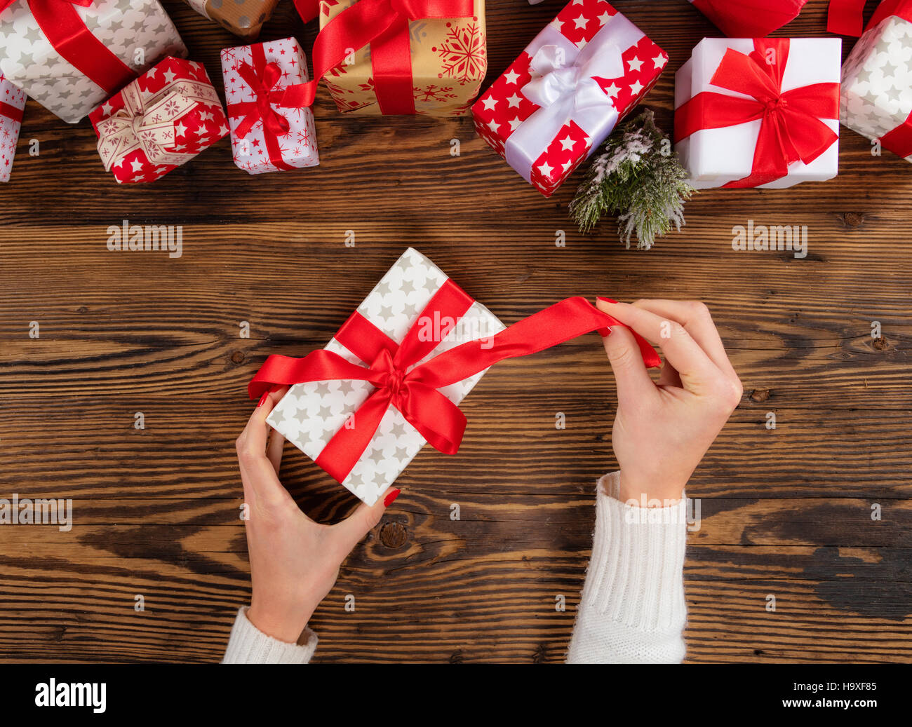 Woman hand packing gifts Stock Photo - Alamy