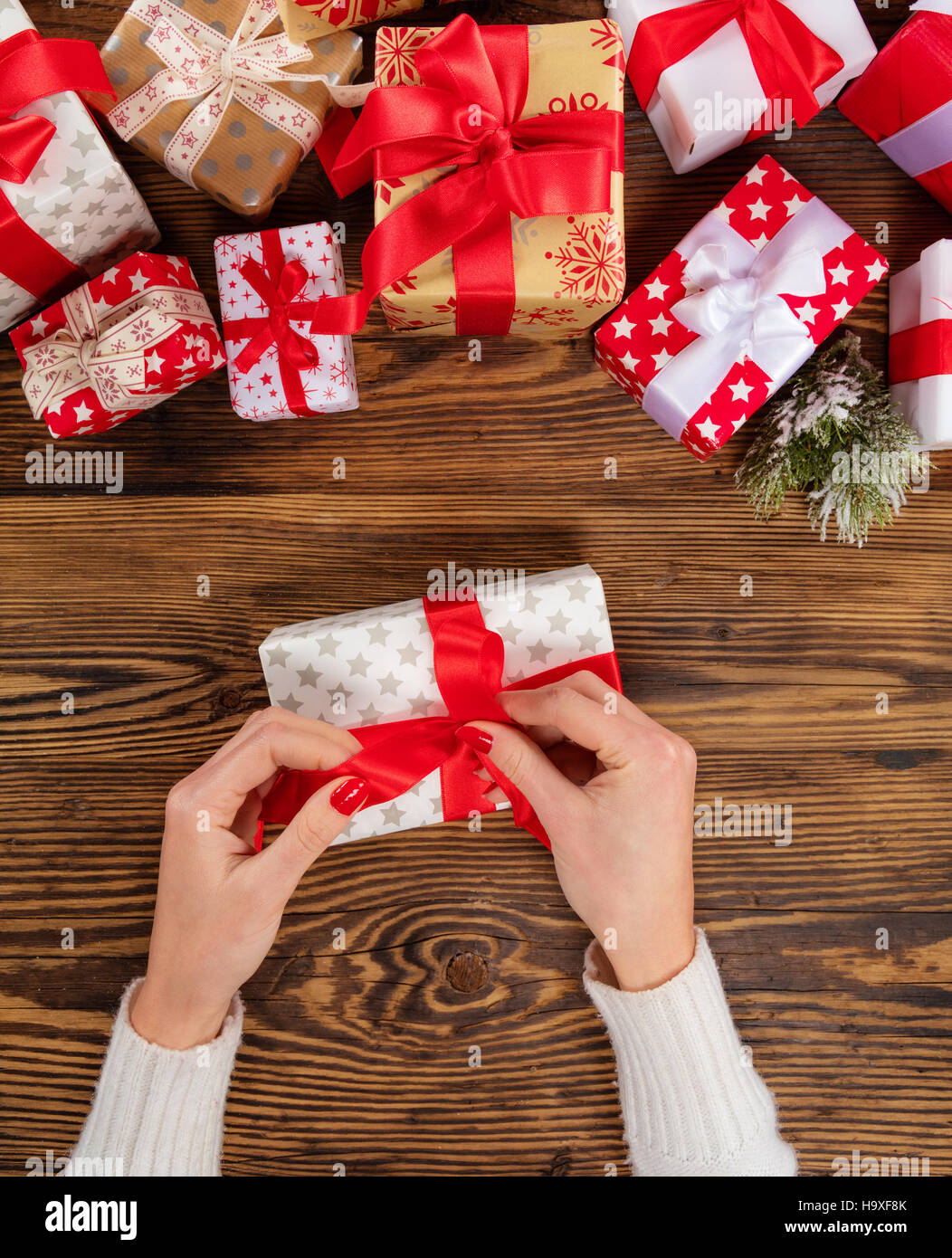 Woman hand packing gifts Stock Photo - Alamy
