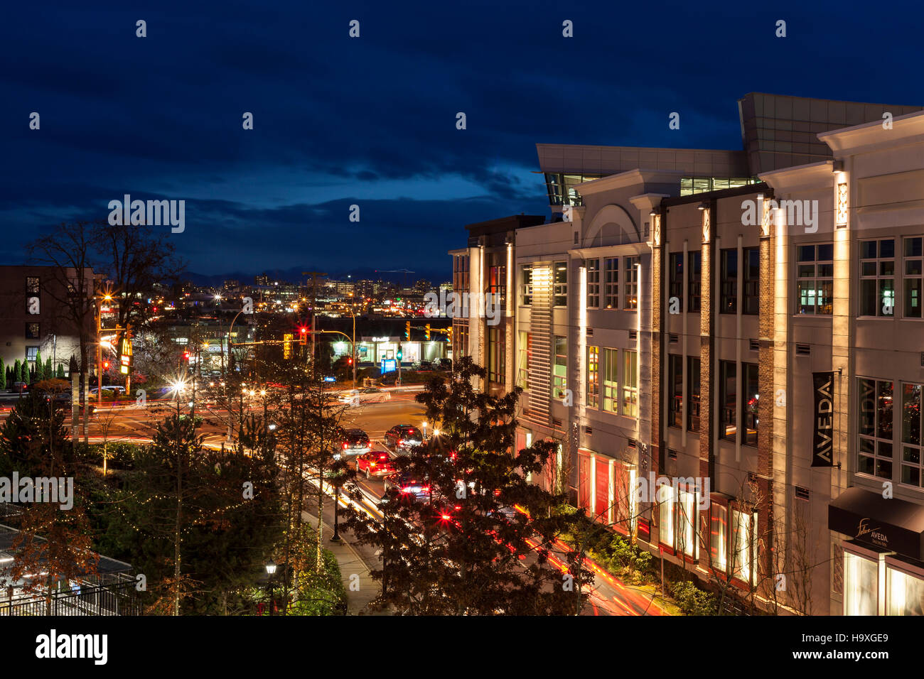 Entrance to Uptown Shopping Mall and commuter traffic at twilight ...