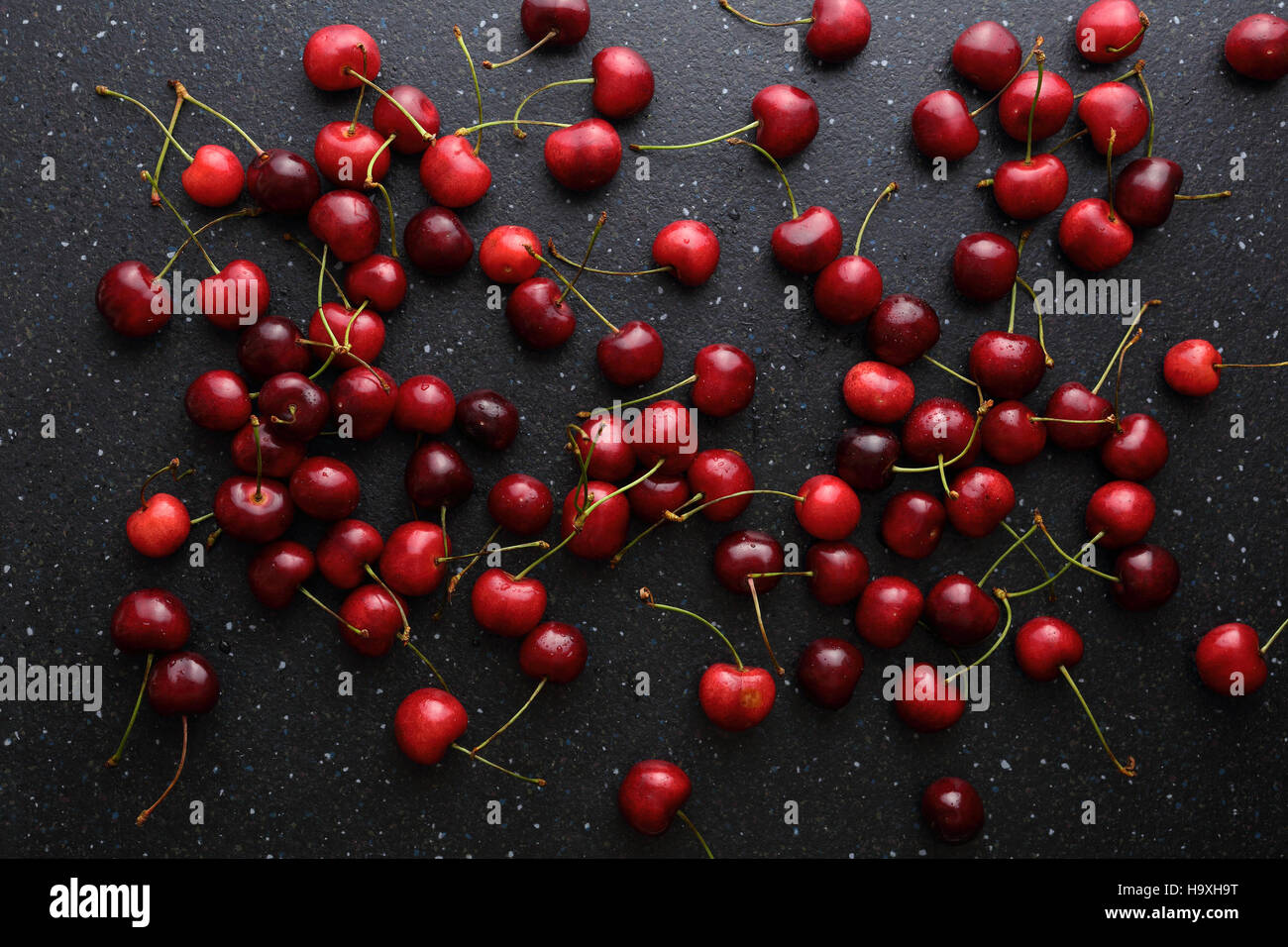 Red cherry on black background, food top view Stock Photo - Alamy