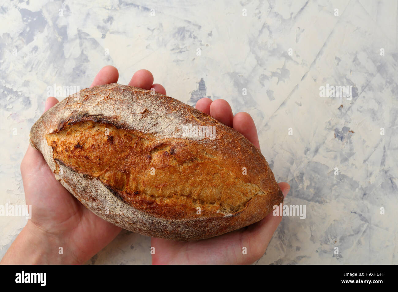 Fresh bread in human hands, food background Stock Photo - Alamy