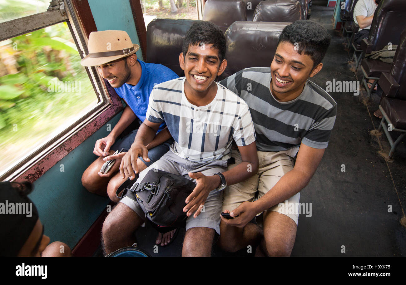 Young guys on a train from Bentota to Galle Stock Photo - Alamy