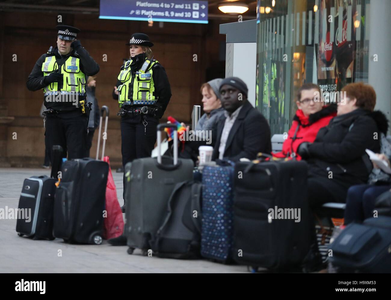 British Transport Police officers hand out leaflets to members of the ...