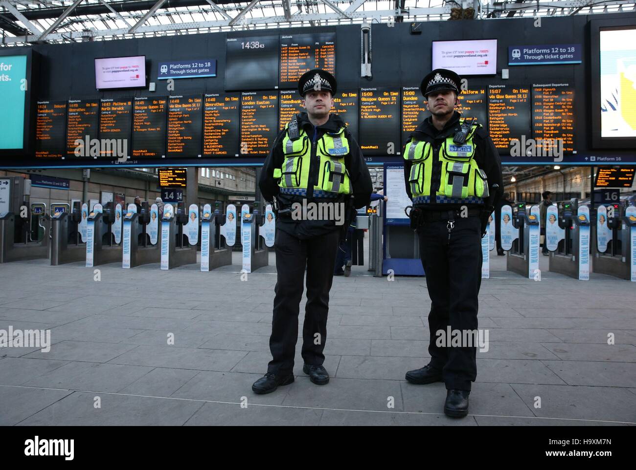 British Transport Police officers hand out leaflets to members of the ...