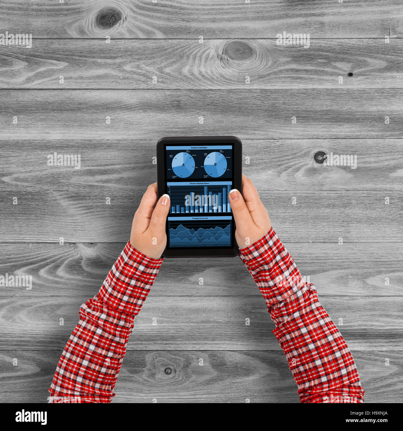 Top view of girl hands using tablet pc with diagrams and graphs on ...