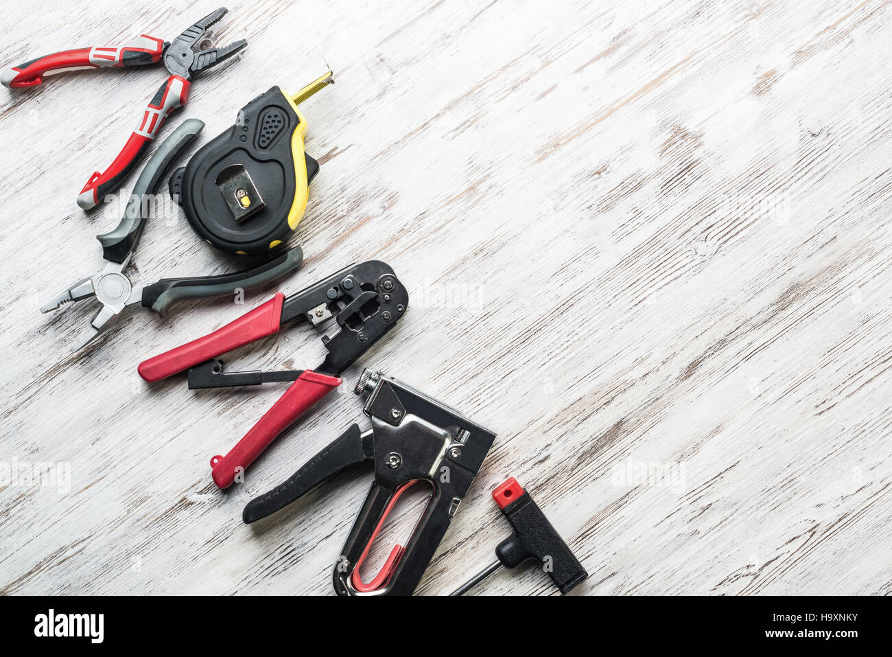 Variety of repair tools on wooden surface Stock Photo - Alamy