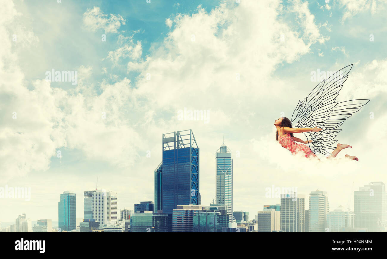 Young woman flying high in blue sky Stock Photo - Alamy