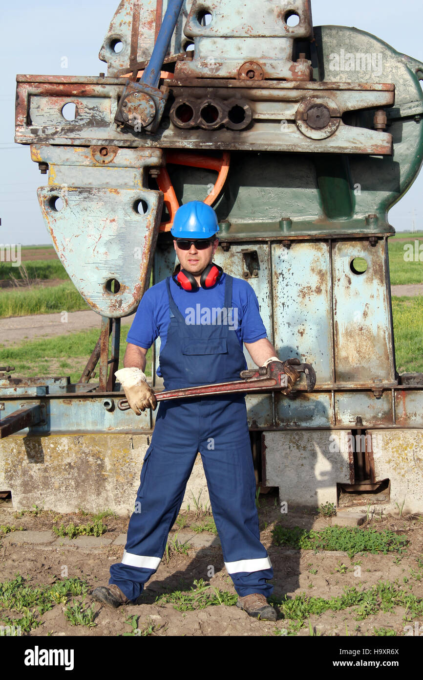 oil worker with pipe wrench Stock Photo - Alamy
